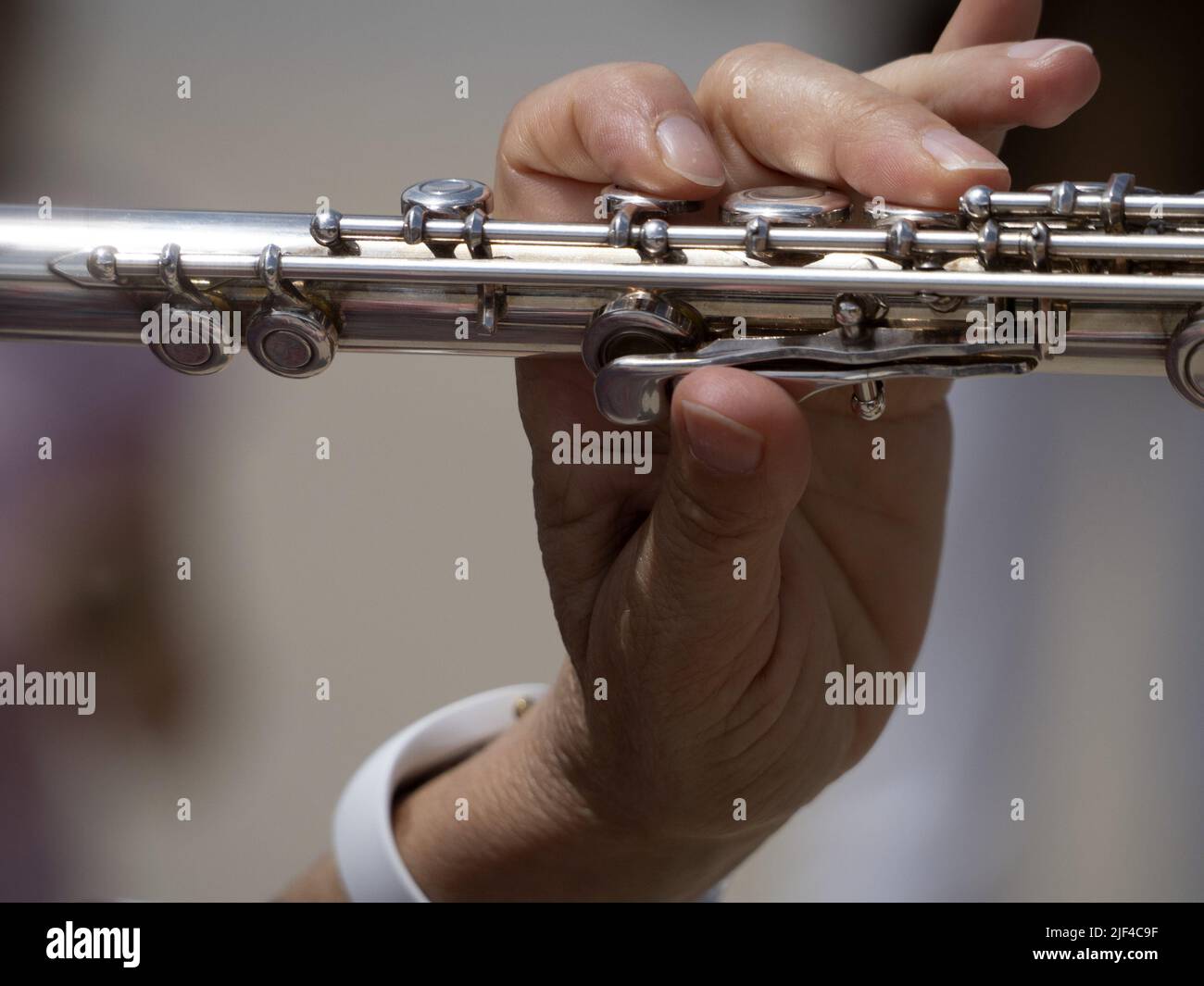 woman hands playing traverse flute detail Stock Photo - Alamy