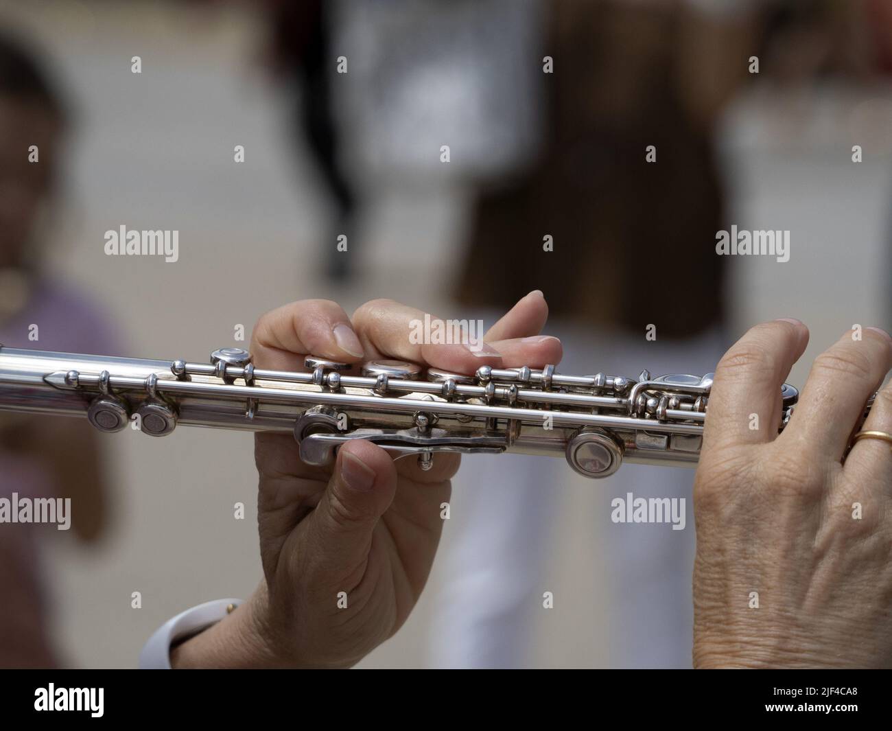 woman hands playing traverse flute detail Stock Photo - Alamy