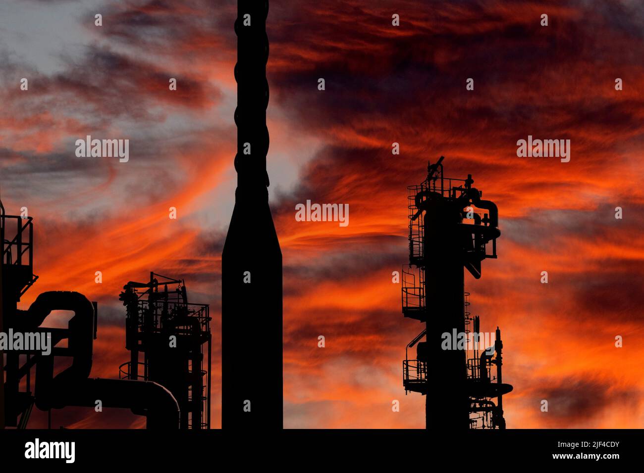oil refinery silhouette isolated on red war smoke and fire background ...