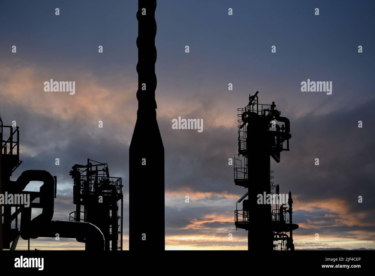 oil refinery silhouette isolated on sunset background Stock Photo - Alamy