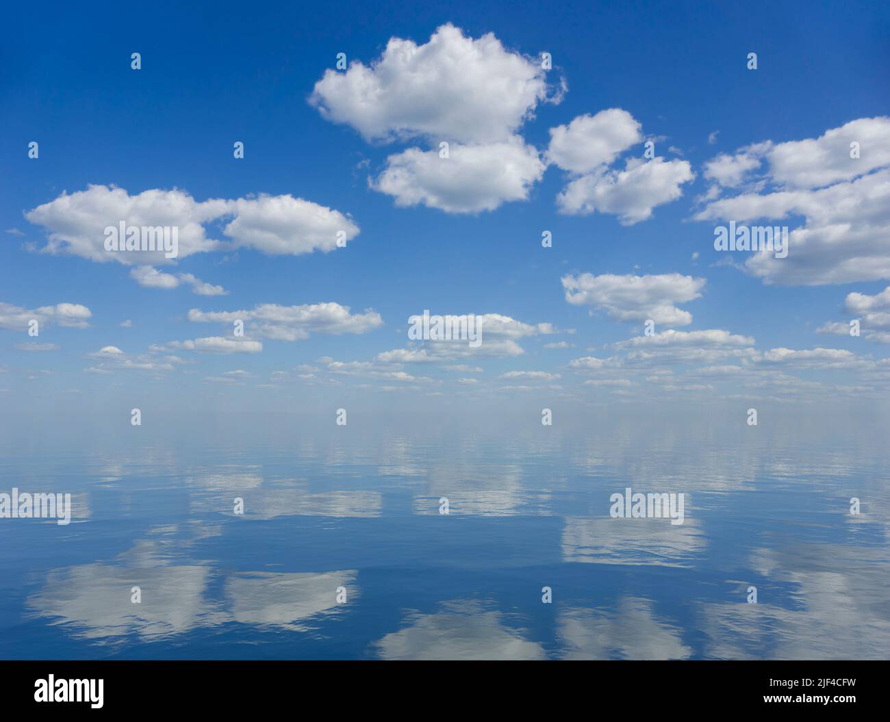 sky and water. a calm landscape of clouds reflecting in the water Stock Photo - Alamy