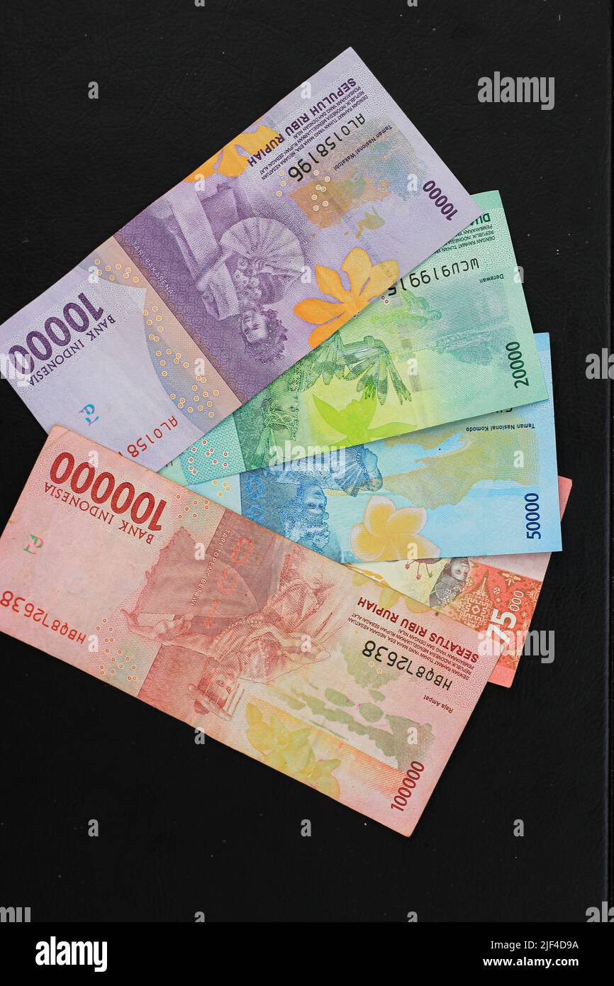 A vertical shot of Indonesian rupiahs on the black background Stock ...