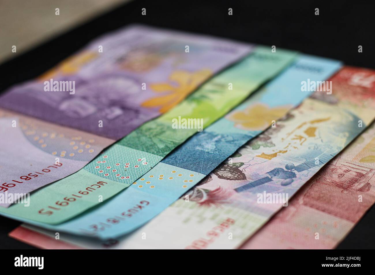 A closeup shot of Indonesian rupiahs on the black background Stock ...