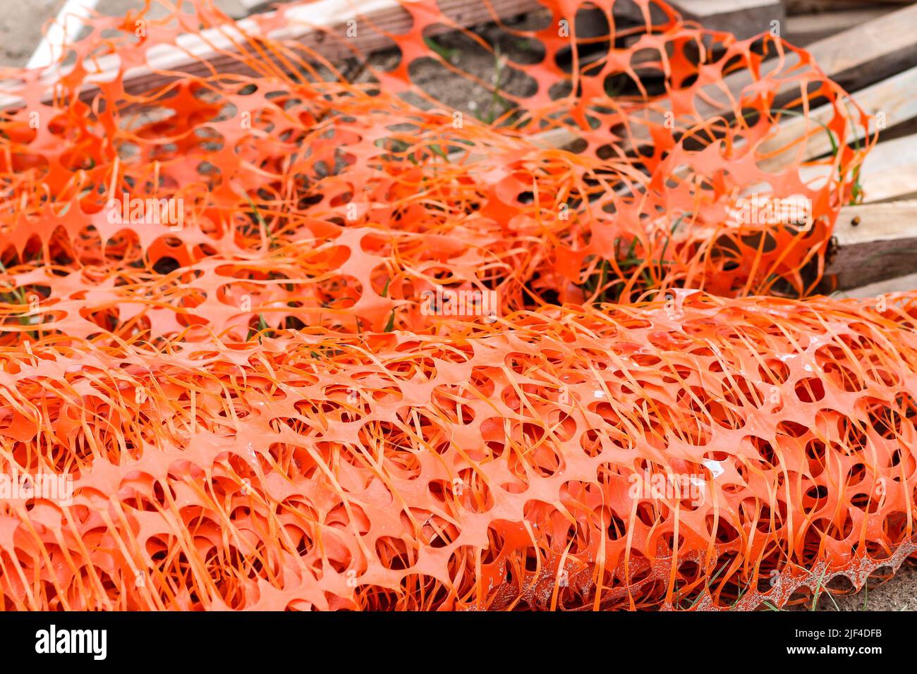 An orange-colored flat plastic wire mesh - a safety fencing net Stock ...