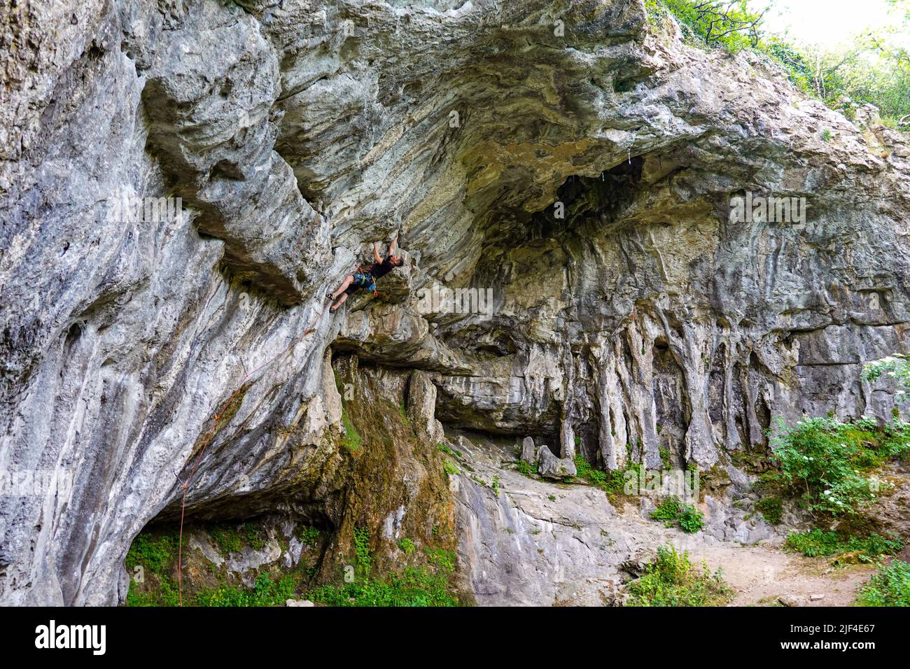 Rock climber on steep limestone cliff at Giggleswick near Ingleton ...
