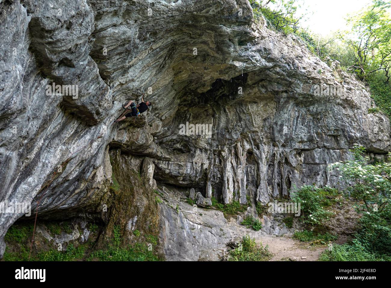 Rock climber on steep limestone cliff at Giggleswick near Ingleton ...