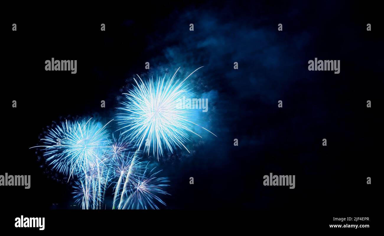 Fantastic vibrant arctic blue fireworks splashing in the night sky ...
