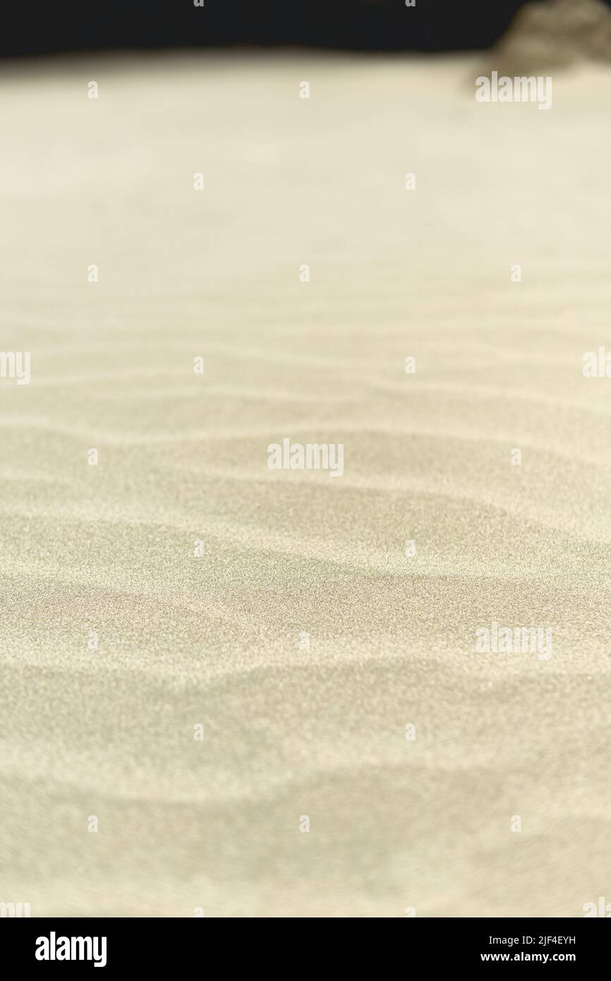 A vertical closeup of pale beige color sand surface Stock Photo - Alamy
