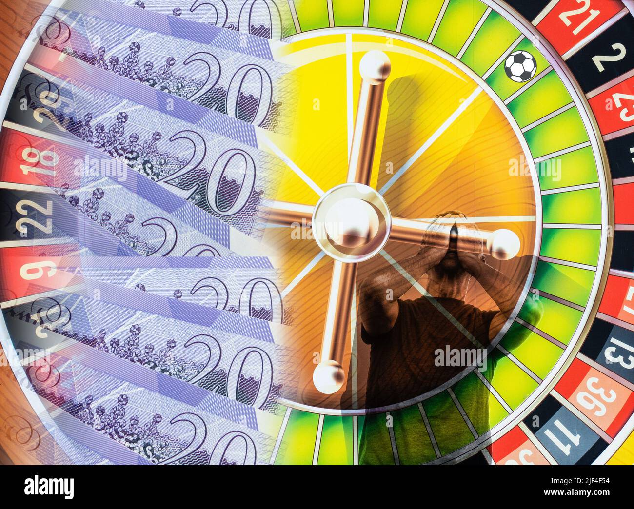 Twenty pound notes on roulette wheel with man with hands over face ...