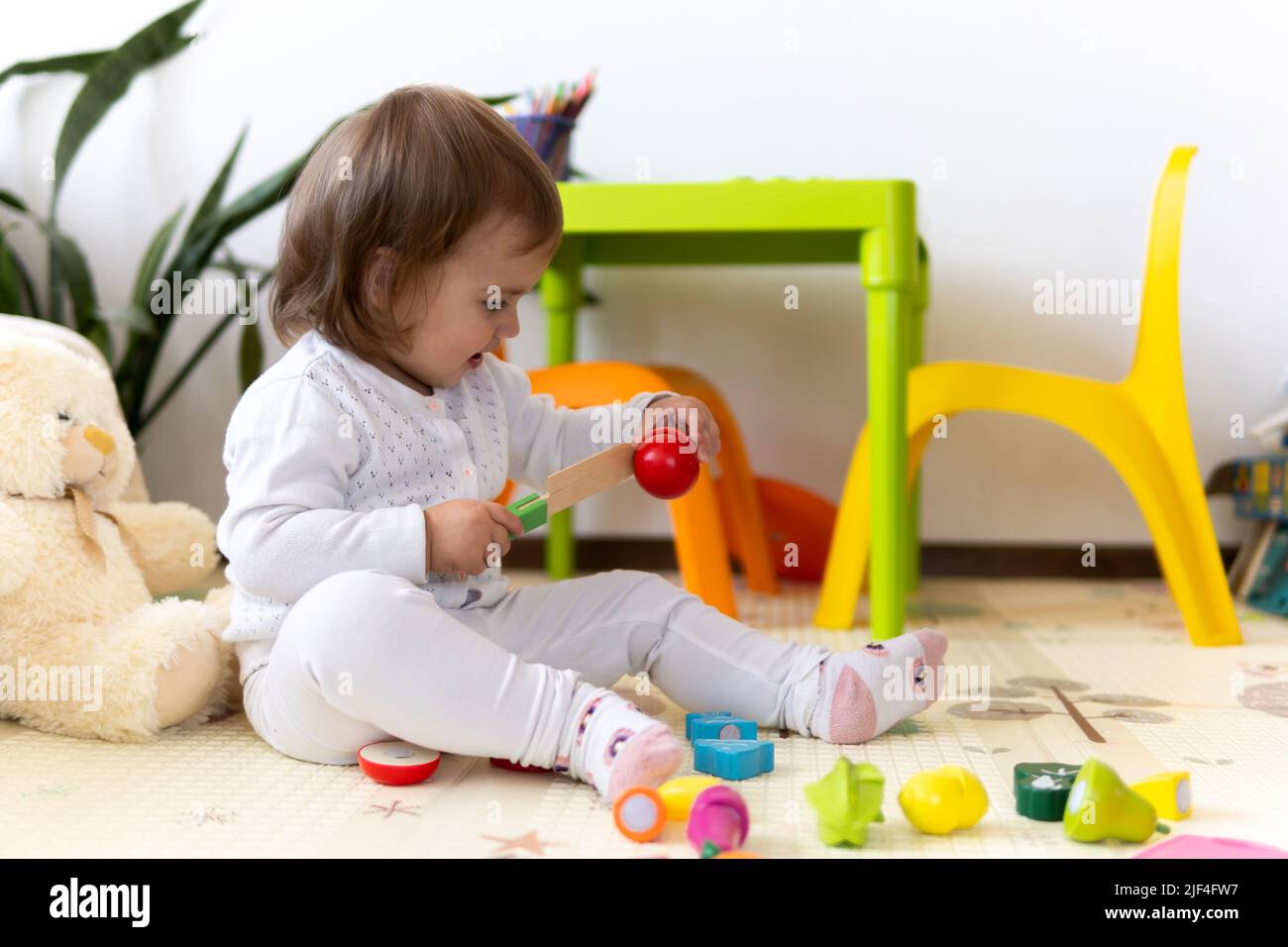 happy funny kid curly baby girl with educational toy blocks flowers ...