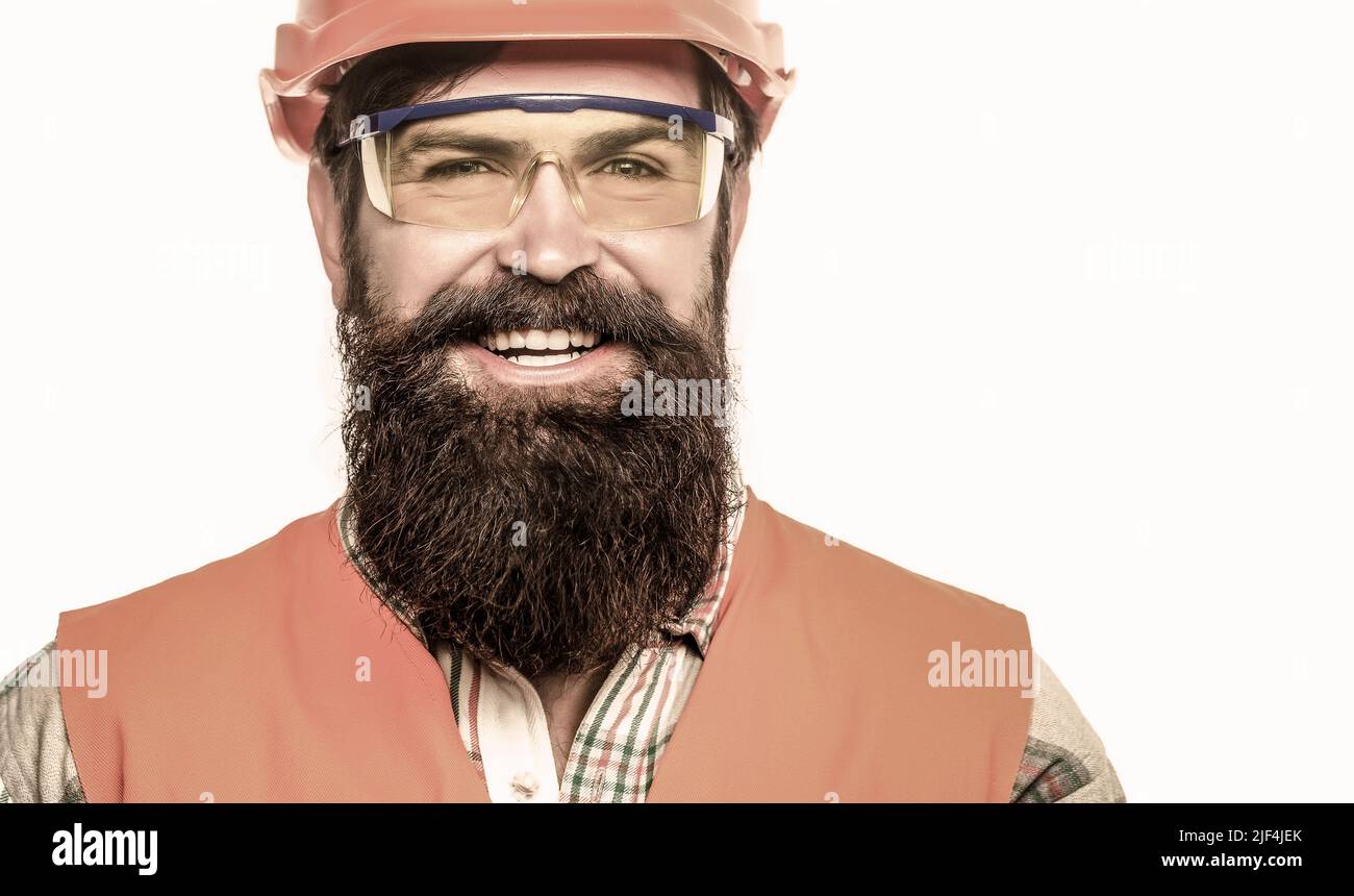 Portrait of a builder smiling. Builder in hard hat, foreman or ...