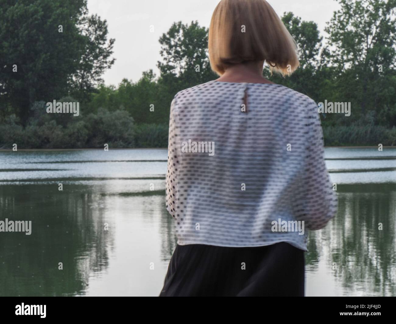 female pensioner having fun and smoking a cigarette in a park - aging ...