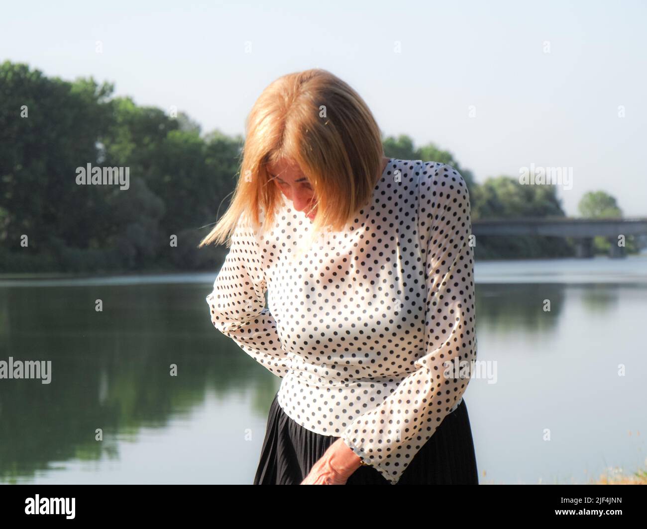 single female pensioner having fun in a park - aging free and wellness ...