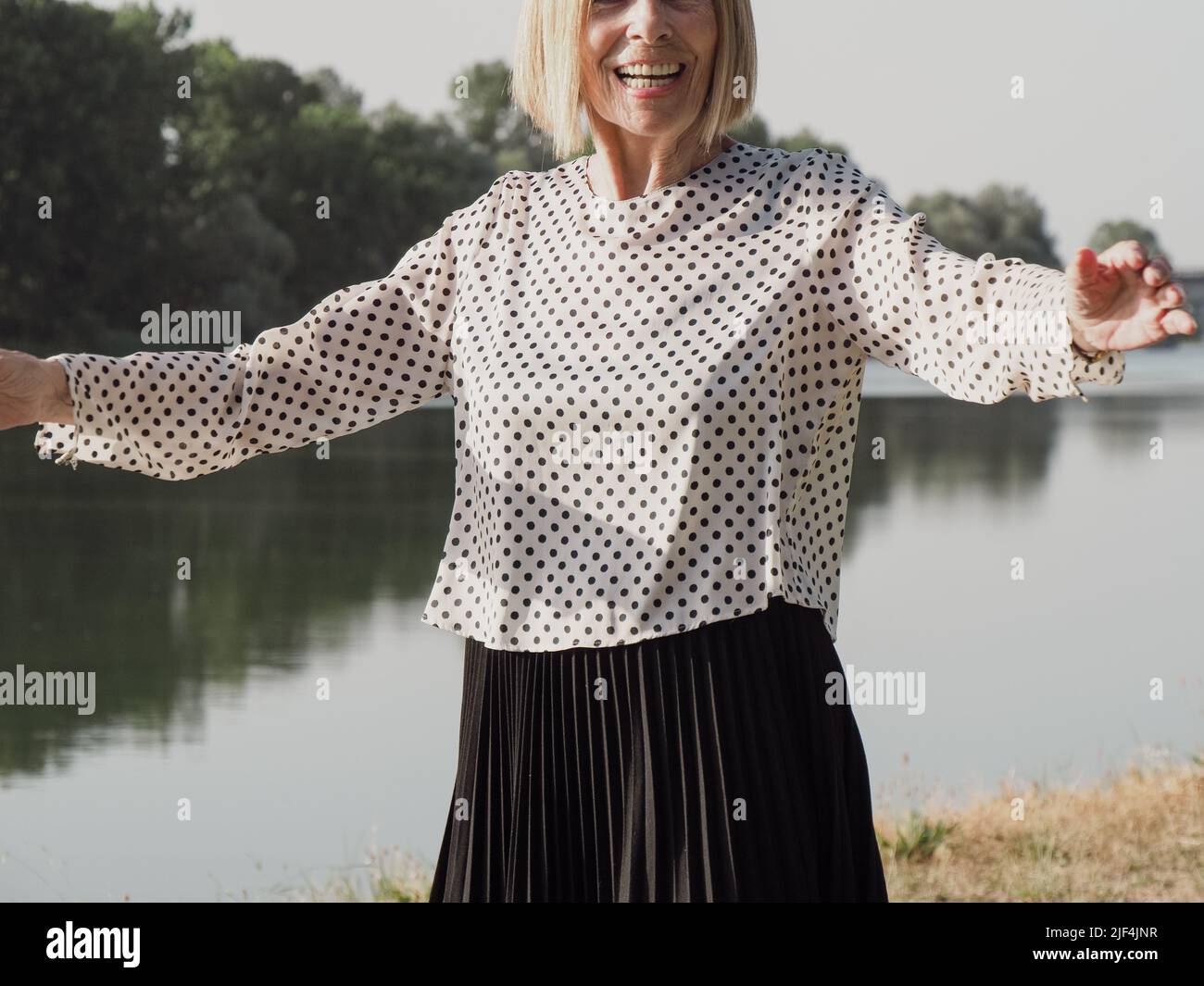 single female pensioner having fun in a park - aging free and wellness ...