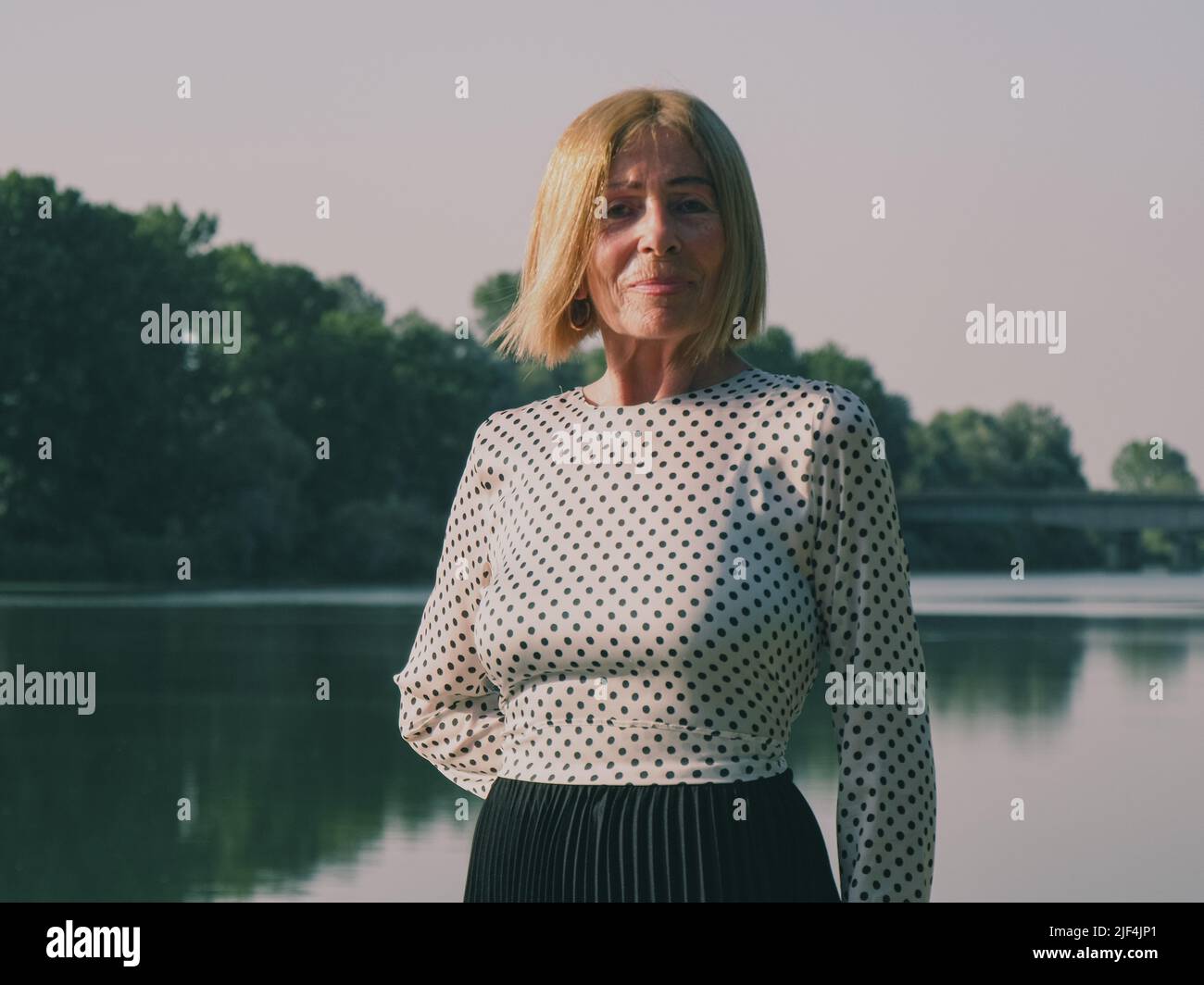 single female pensioner having fun in a park - aging free and wellness ...