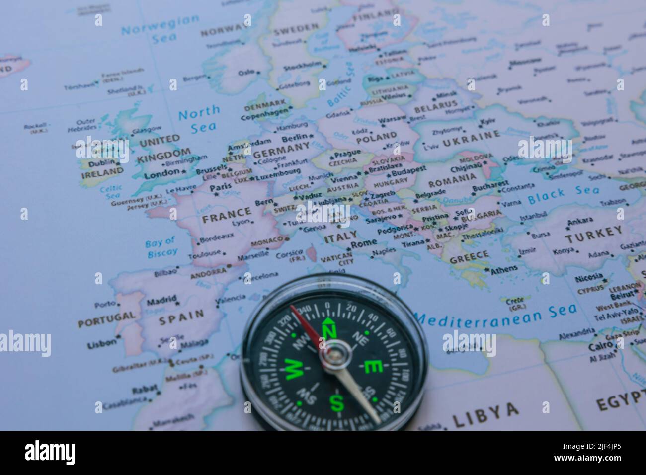 Travel to Europe background photo. A compass on the Europe map in focus ...