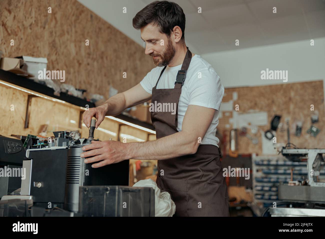 Man fixing coffee machine hi-res stock photography and images - Alamy