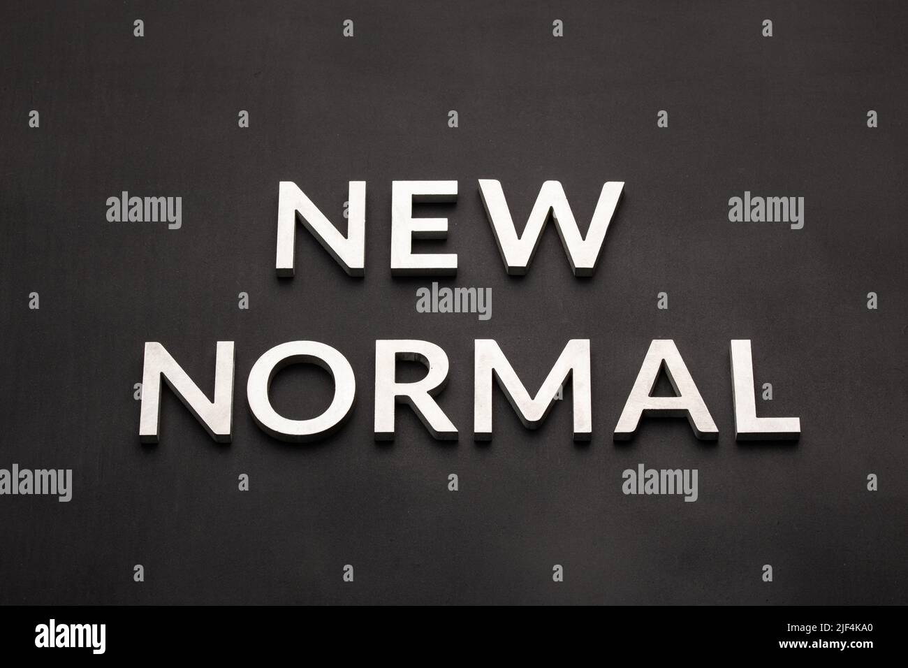 Words new normal on black surface in flat lay perspective Stock Photo ...