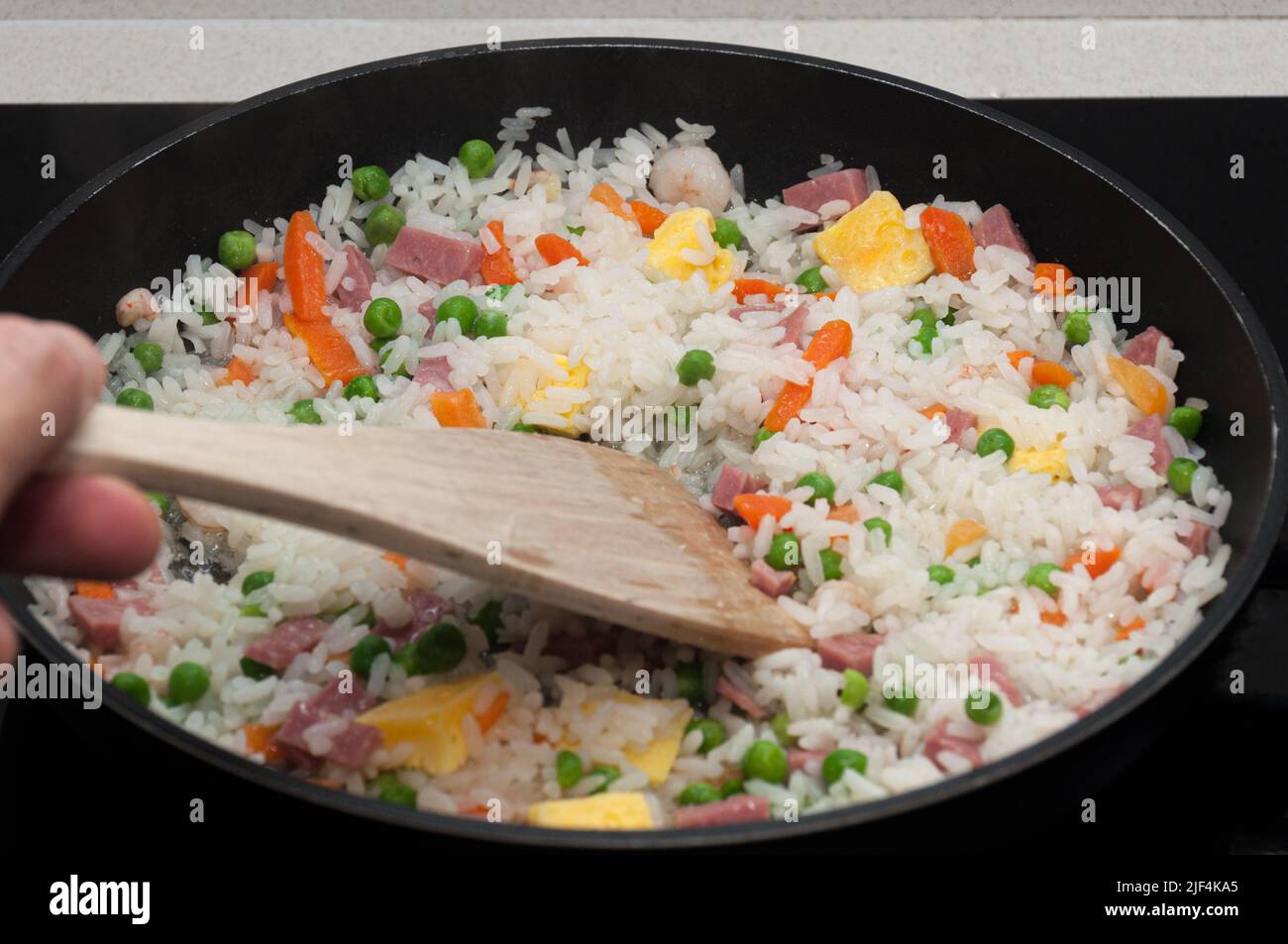 Rice three delights with the wooden cooking spade Stock Photo - Alamy