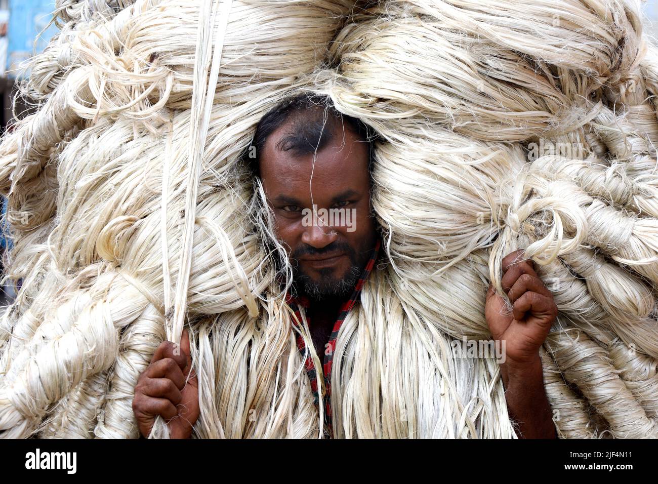 June 29, 2022, manikgonj, Manikgonj, Bangladesh: A man is carrying a ...