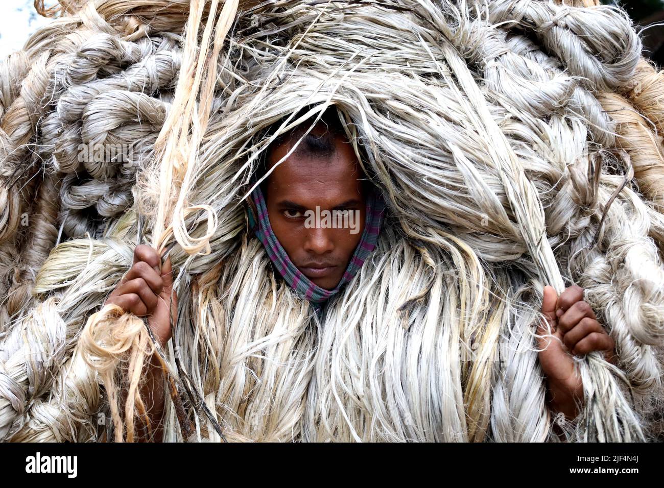 June 29, 2022, manikgonj, Manikgonj, Bangladesh: A man is carrying a ...