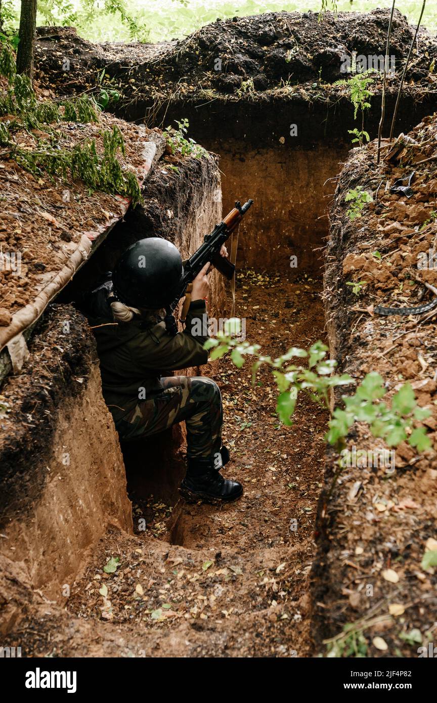 A soldier in a trench on the front line of the Ukrainian-Russian war ...