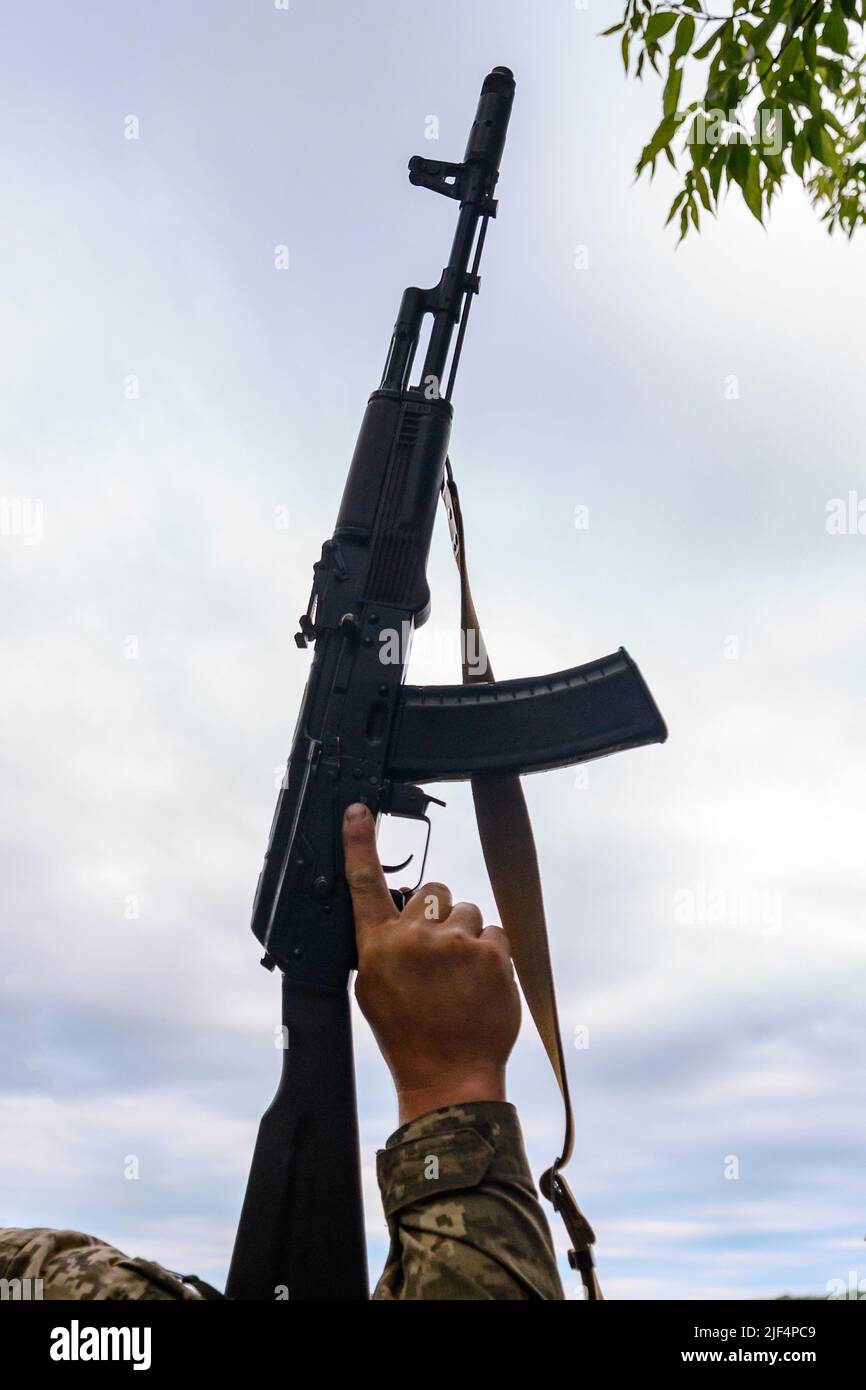The Ukrainian military holds a submachine gun. hand with a machine gun ...