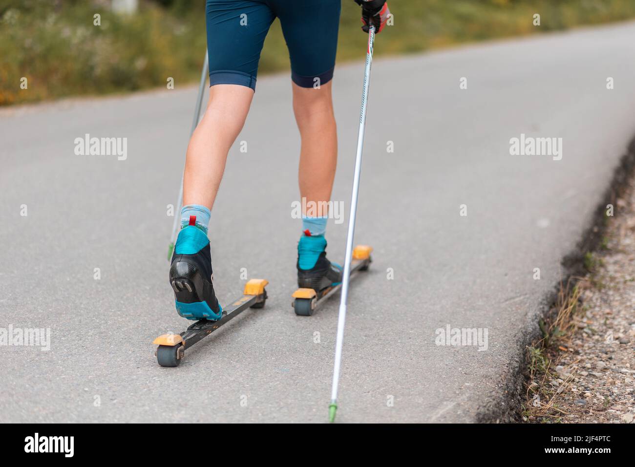 Legs of a biathlete athlete with ski poles, close-up. Concept of ...