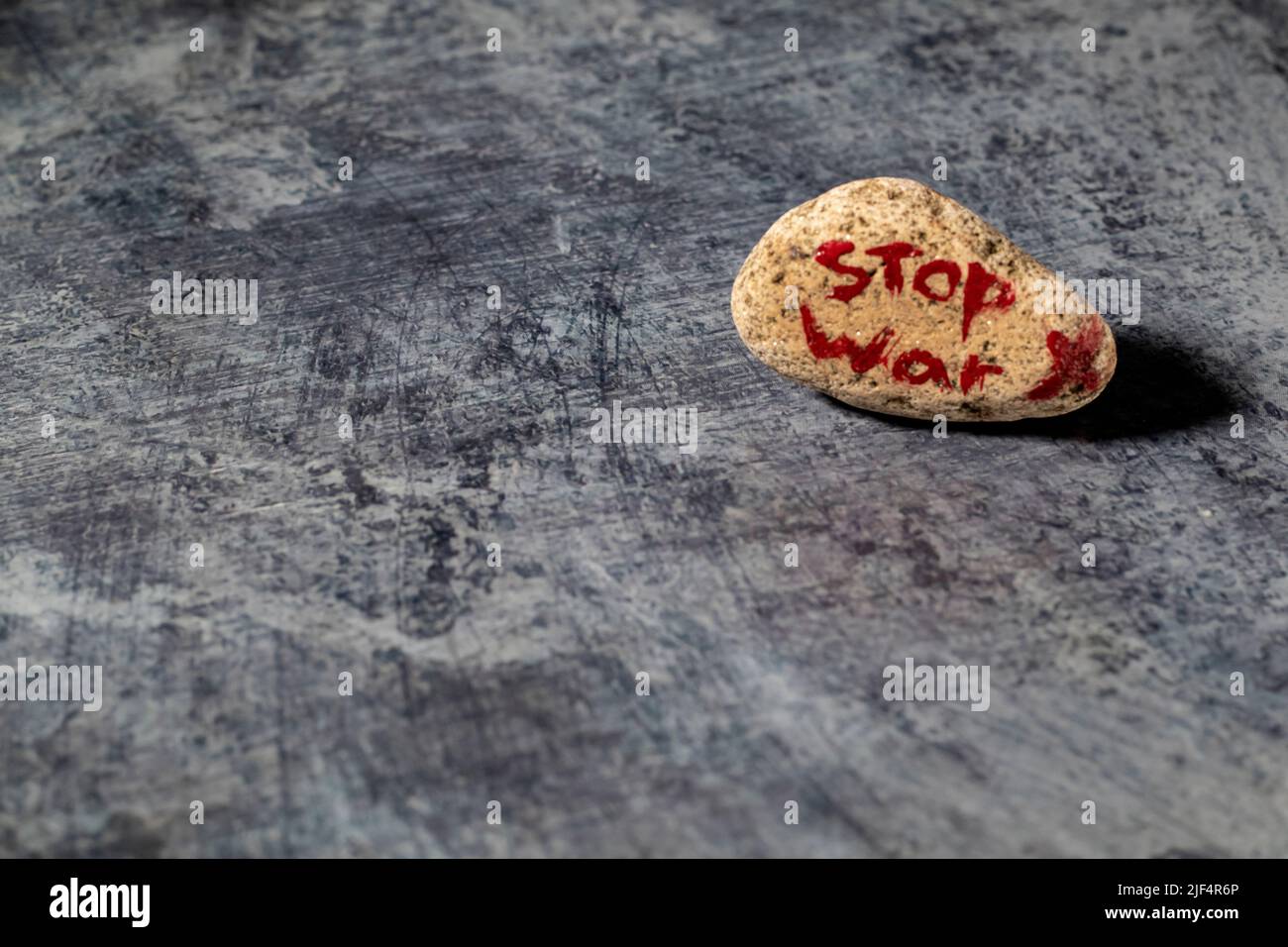 Stone with the inscription stop war on a concrete wall. Concept ...