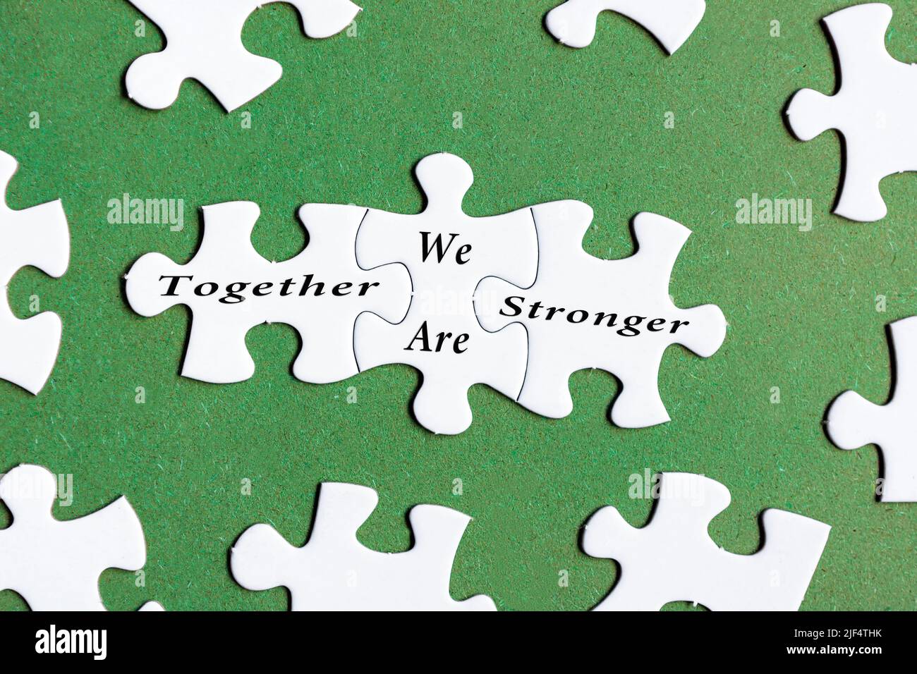 Motivational and inspirational text on white jigsaw puzzle with green ...