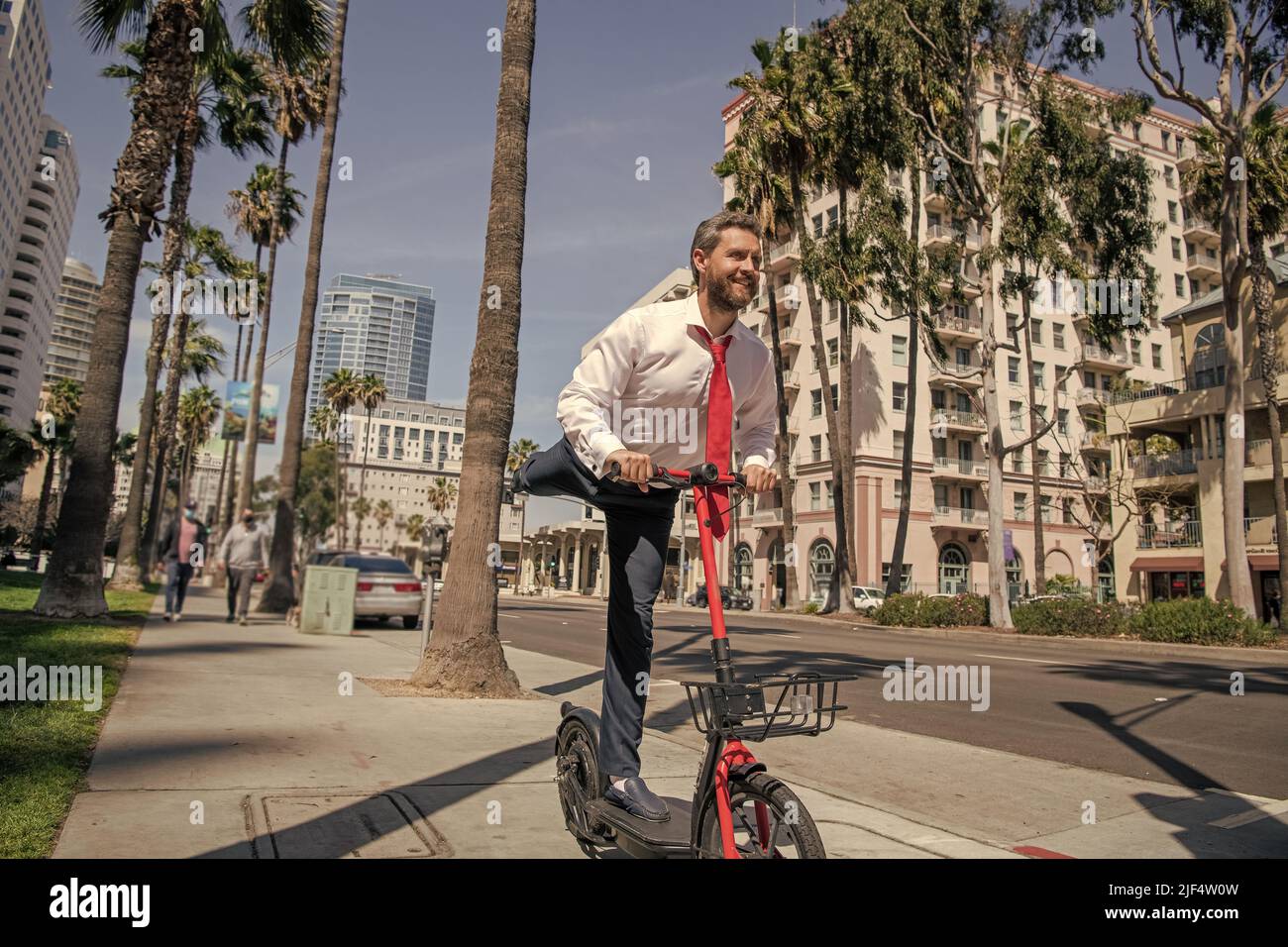 Happy active professional man have fun riding electric scooter on ...