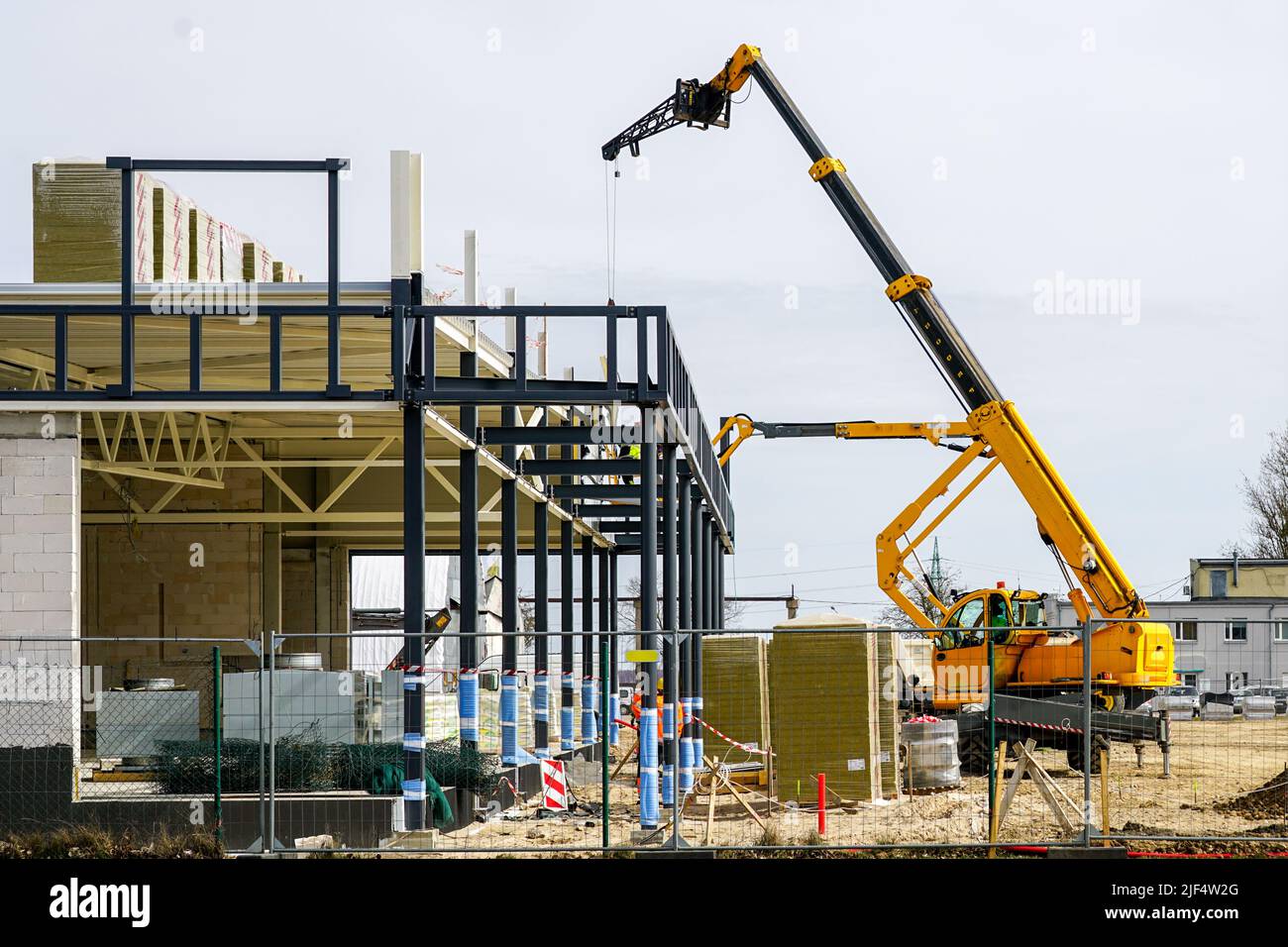 Assembly of a modern building of concrete blocks and metal structures ...