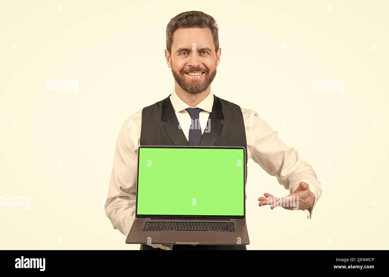 happy businessman presenting computer with green screen for copy space ...