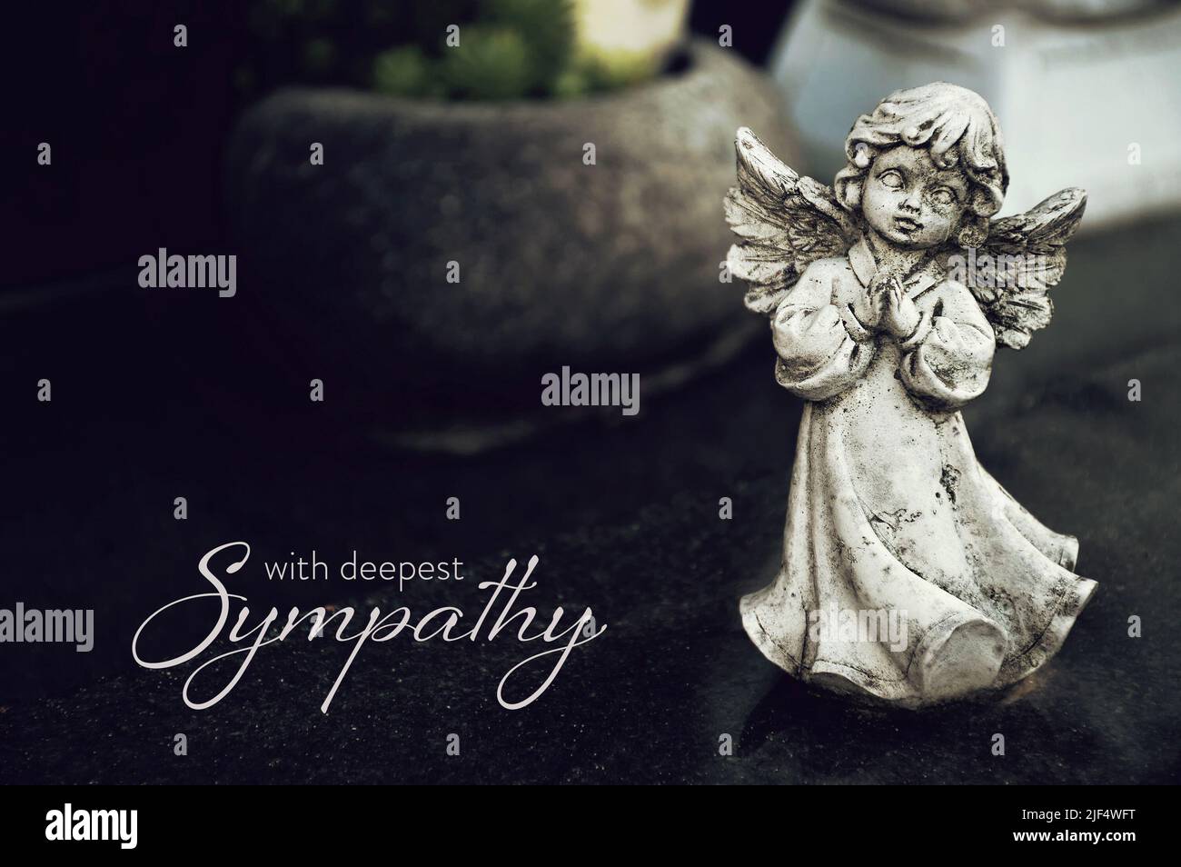 Sympathy card with angel figurine on the grave Stock Photo - Alamy