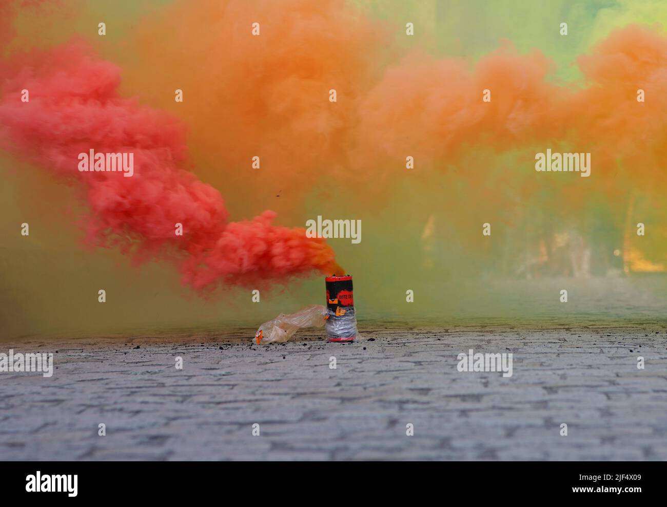 red color smoke bomb on pride day. Red sparkler in a manifestation ...