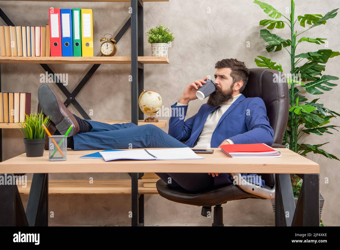 Taking a break from routine. Businessman drink coffee in office ...