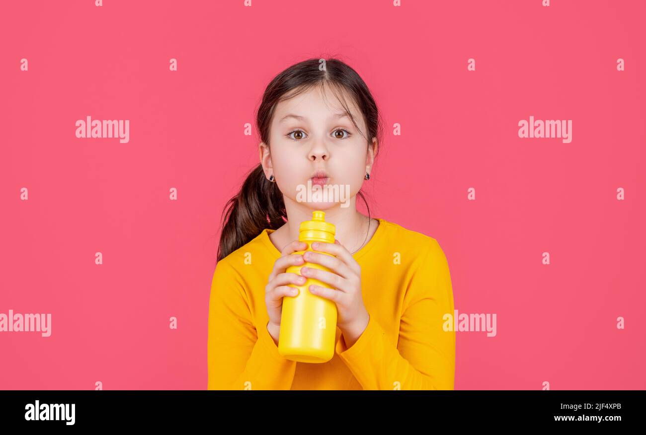 funny kid drink water on pink background Stock Photo - Alamy