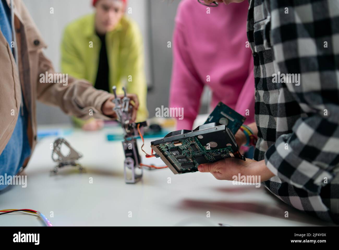 Kids with teacher working together on project with electric toys and ...