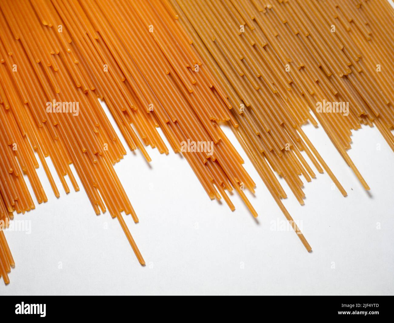 Pasta on the table. Spaghetti of two types on a white background ...