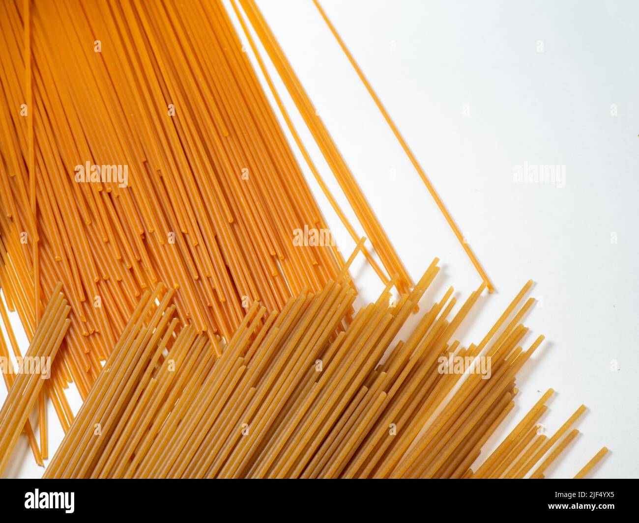 Pasta on the table. Spaghetti of two types on a white background ...