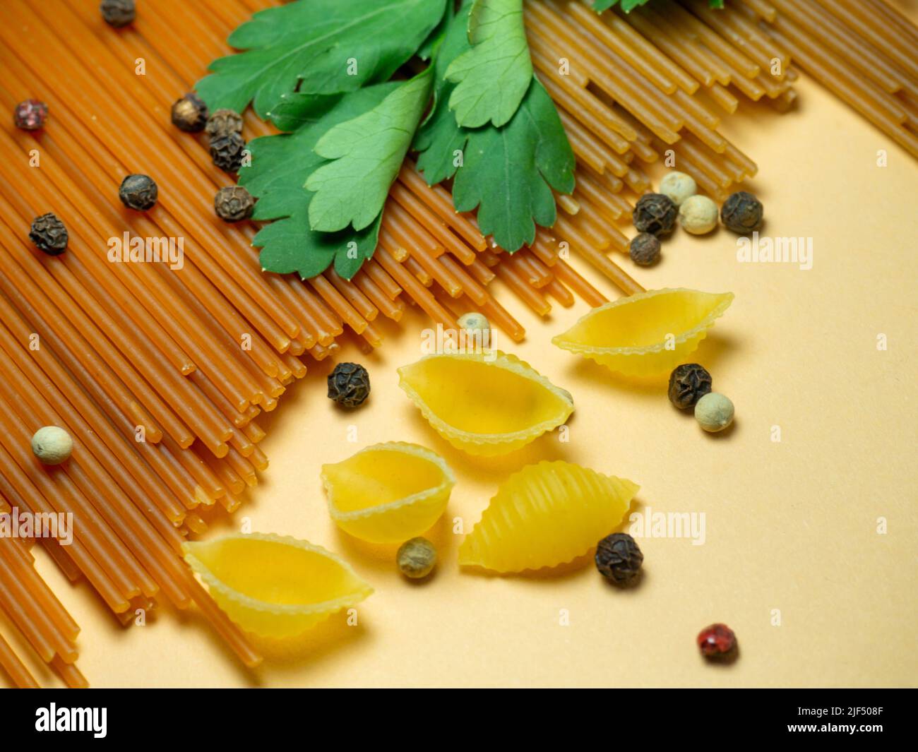 Spaghetti of two types on the table. Tomato and buckwheat pasta ...