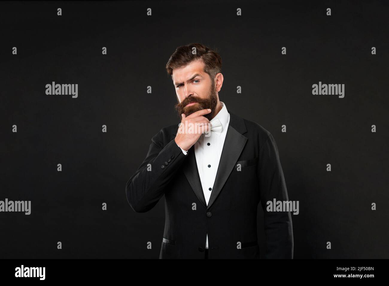 serious luxury man in tuxedo bow tie. gentleman in formalwear on black ...