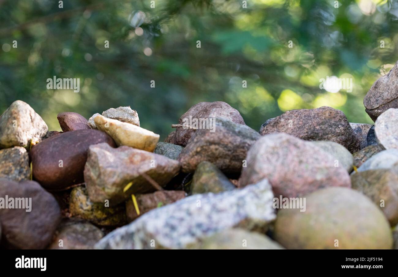 Stacked fieldstones isolated against a blurred background. Natural ...
