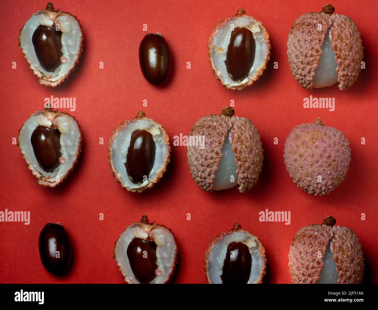 Pattern of cut lychees. Round pimply fruits. Chinese plum. Fruit peel ...
