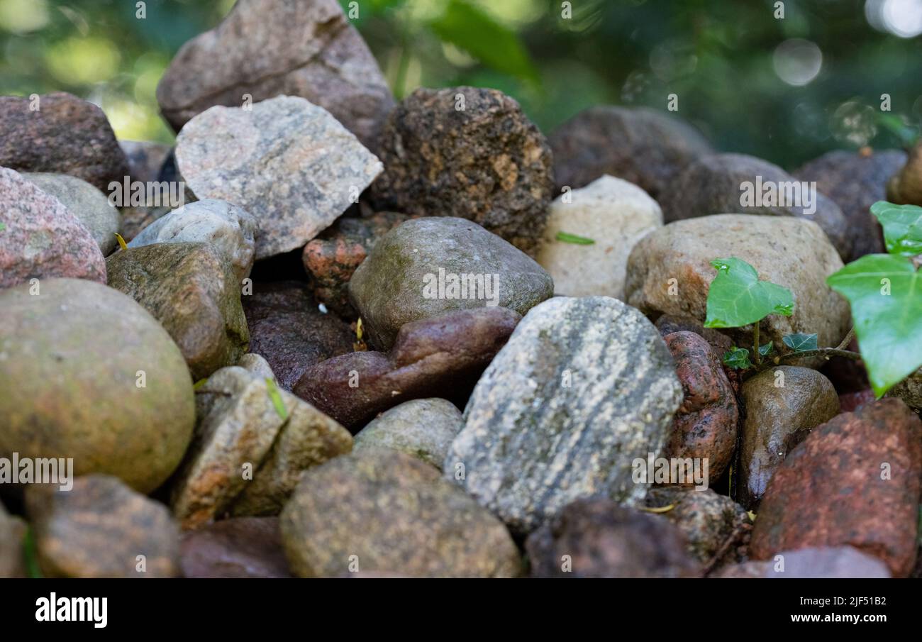 Stacked fieldstones isolated against a blurred background. Natural ...