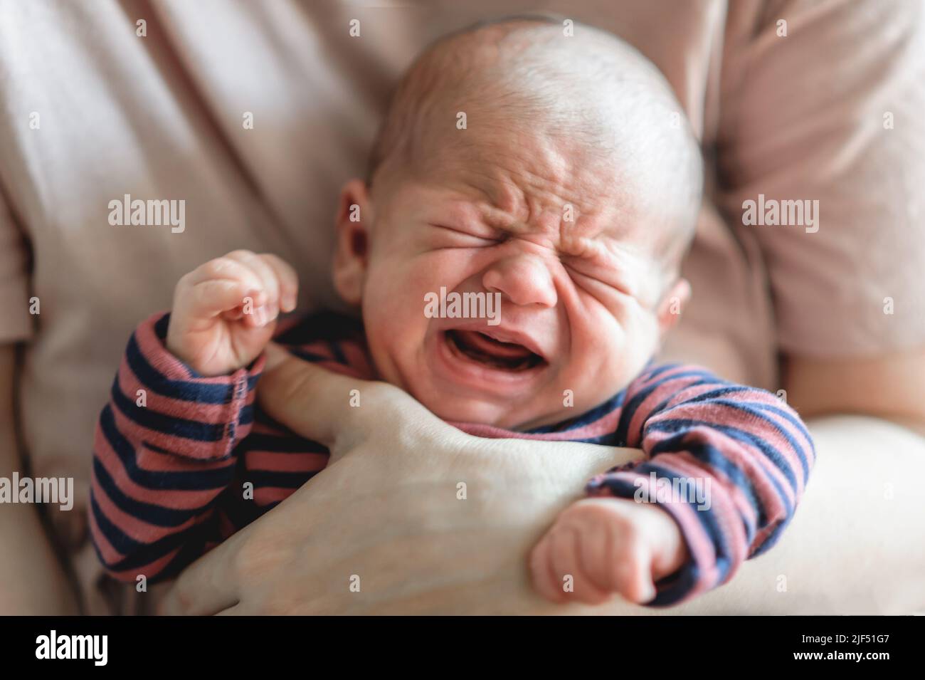 Sweet and cute small little newborn baby is hungry and upset and cry ...