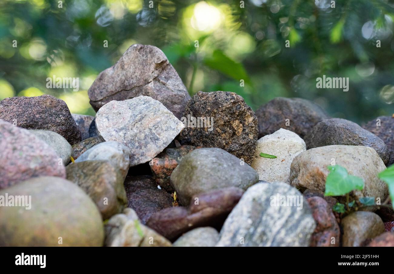 Stacked fieldstones isolated against a blurred background. Natural ...