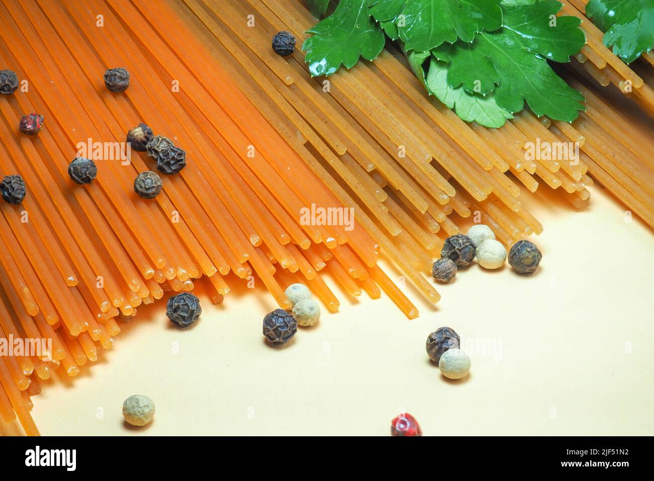 Spaghetti of two types on the table. Tomato and buckwheat pasta ...
