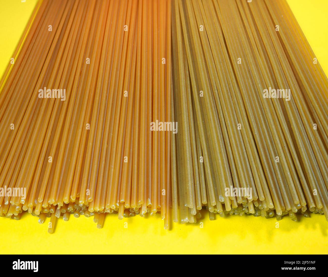 Spaghetti of two types on the table. Tomato and buckwheat pasta ...