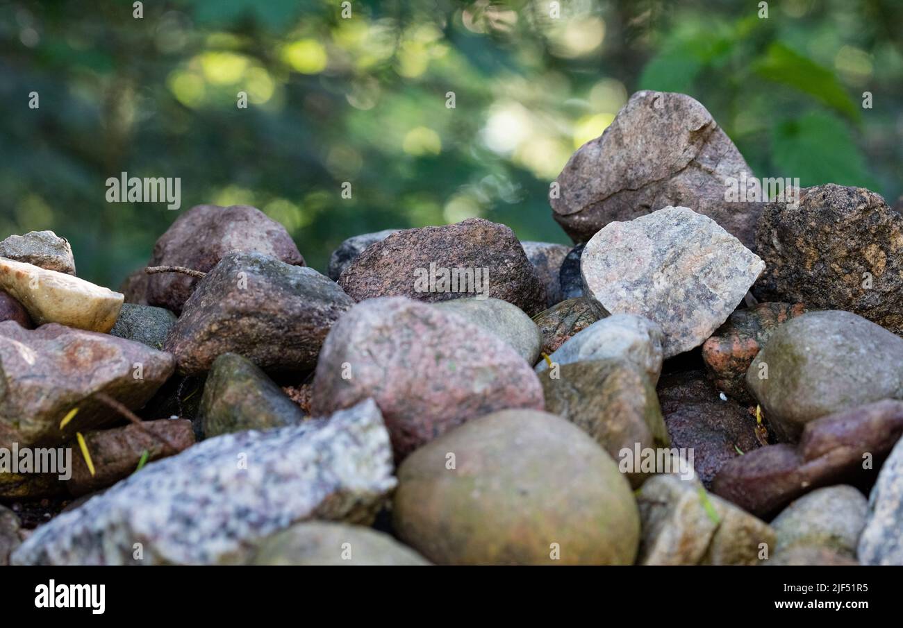 Stacked fieldstones isolated against a blurred background. Natural ...